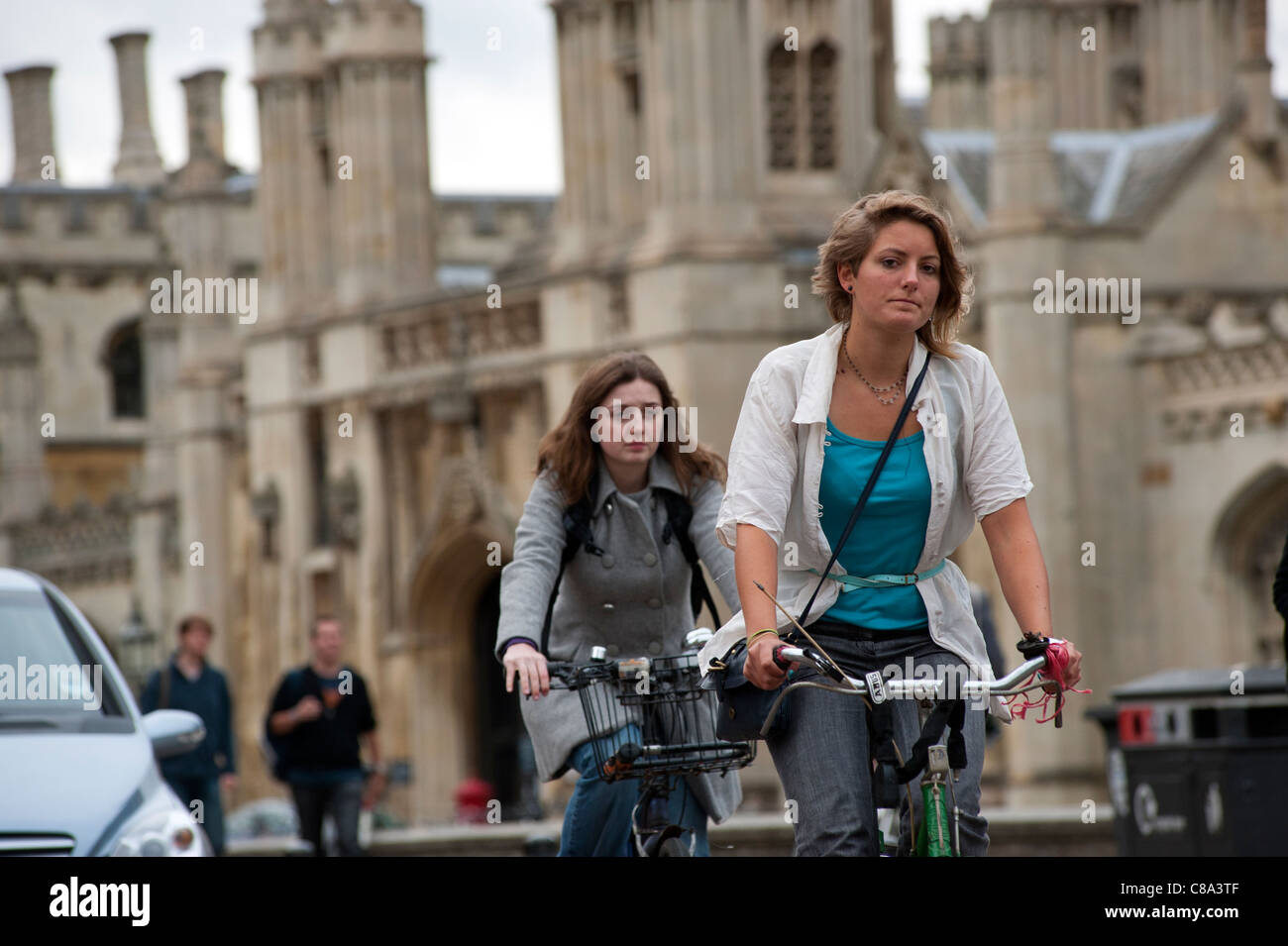 Cambridge University, England. Students cycle past Kings College autumn ...