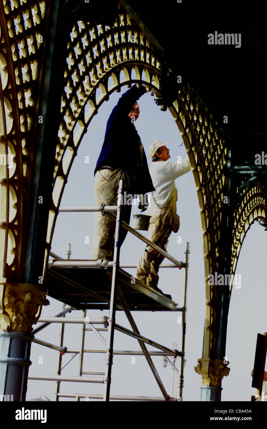 Workmen painting the arches along Brighton's Madeira Drive arches on ...
