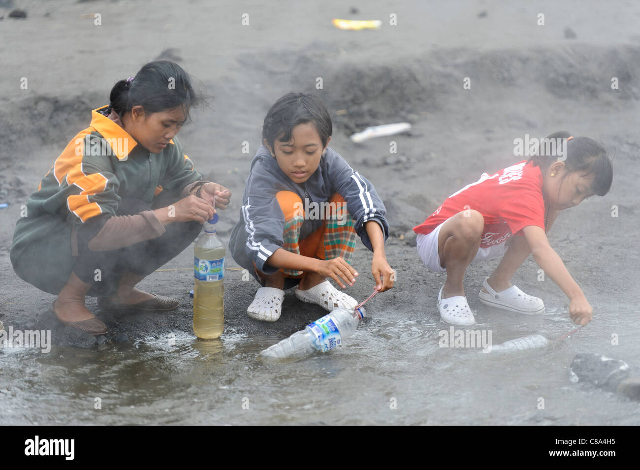 Family at the Gendol river which flows through the remains of a ...