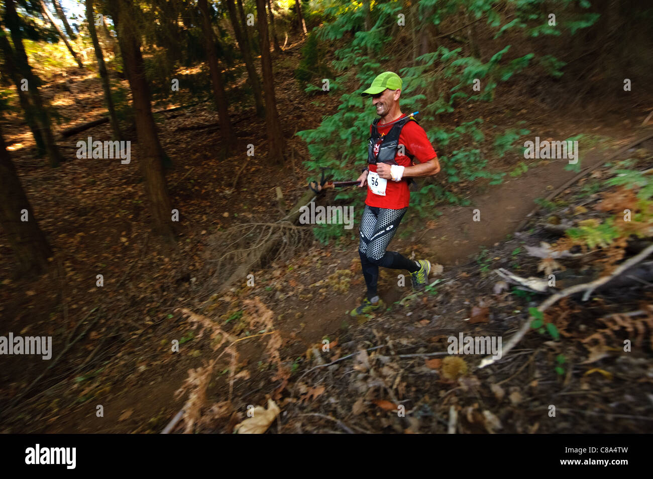 Man running in cross country trail race in forest Stock Photo - Alamy