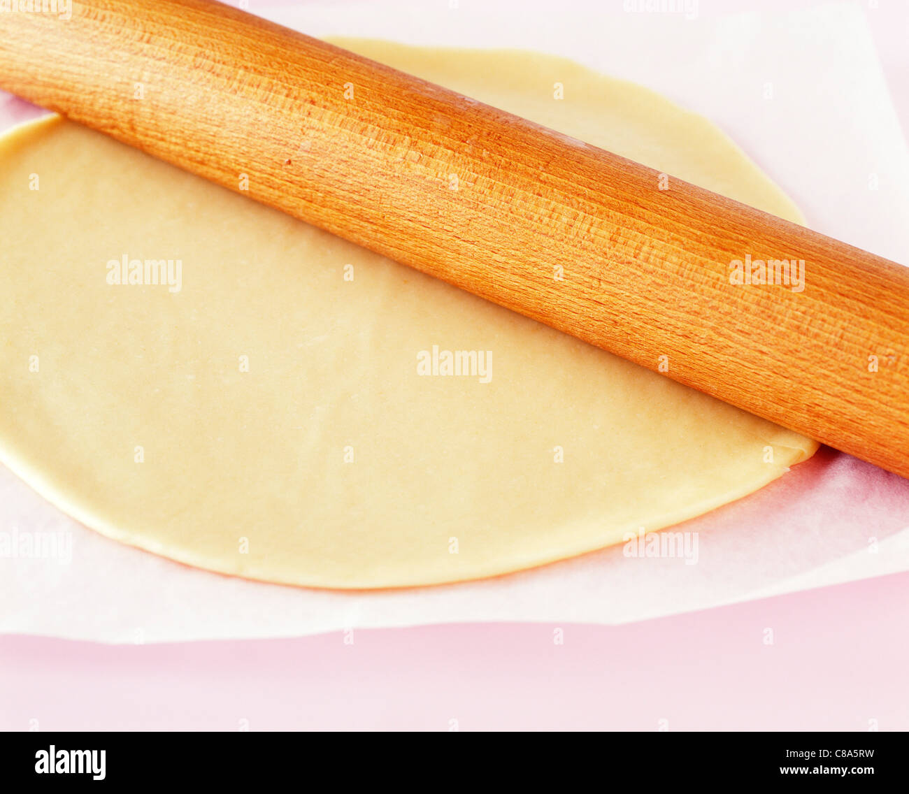 Spreading out the pastry with a rolling pin Stock Photo - Alamy