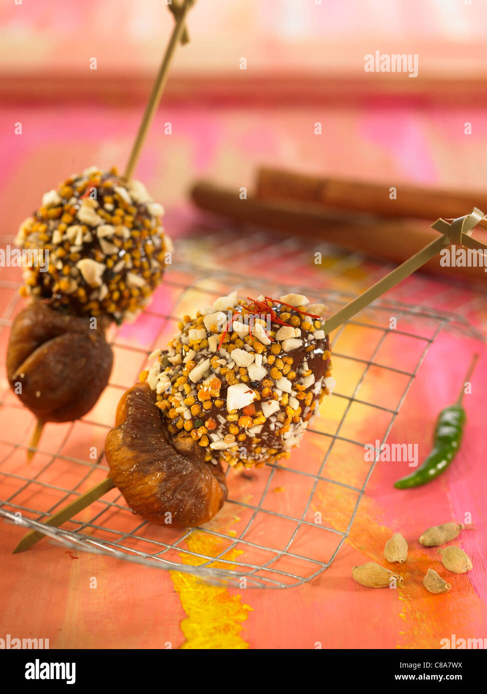 Toffee apple-style spicy fruit brochettes Stock Photo - Alamy