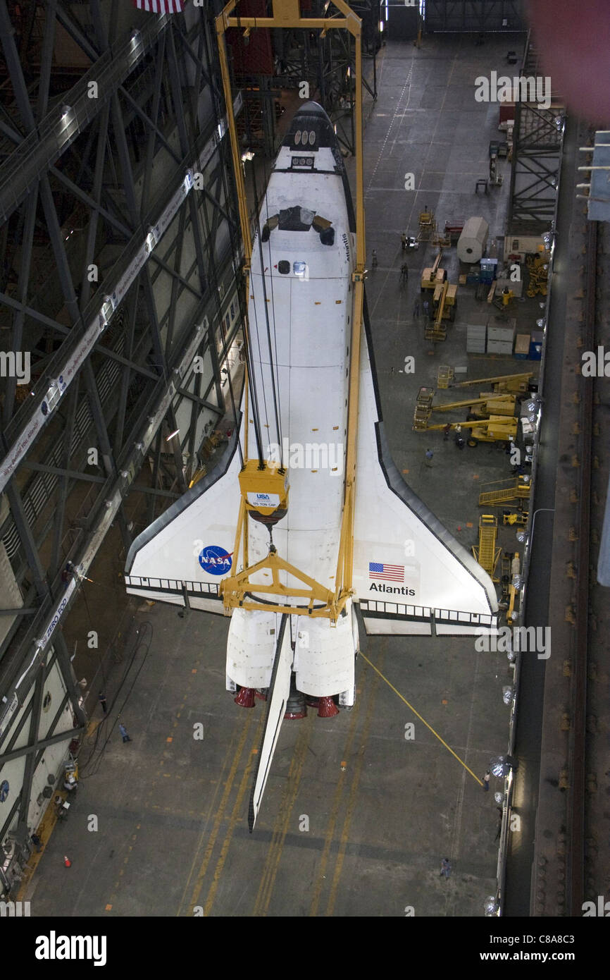 In the Vehicle Assembly Building shuttle Atlantis is suspended over the ...
