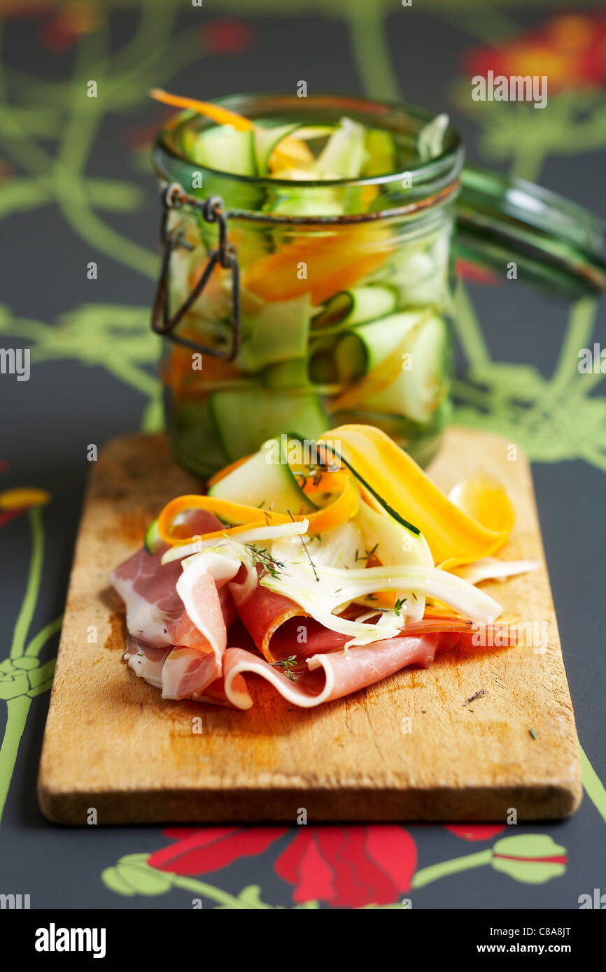 Sliced raw ham with marinated vegetables Stock Photo - Alamy