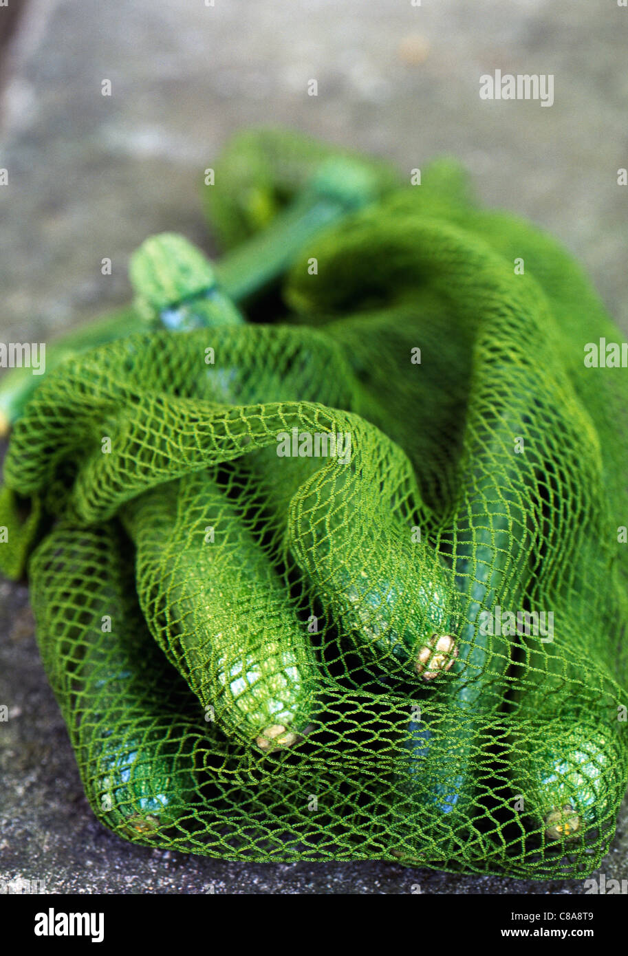 Courgettes in a string bag Stock Photo - Alamy