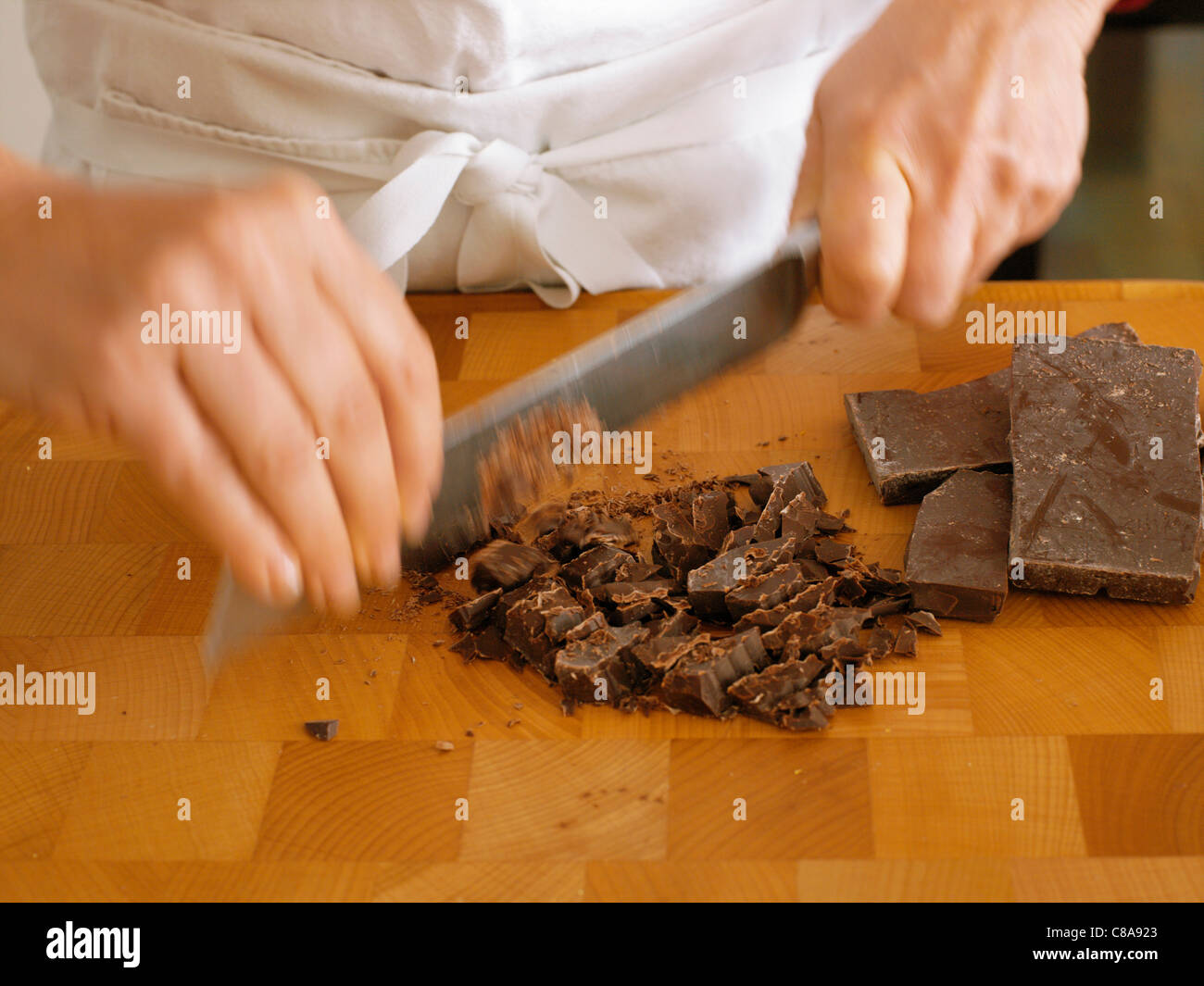 Chopping the chocolate Stock Photo - Alamy