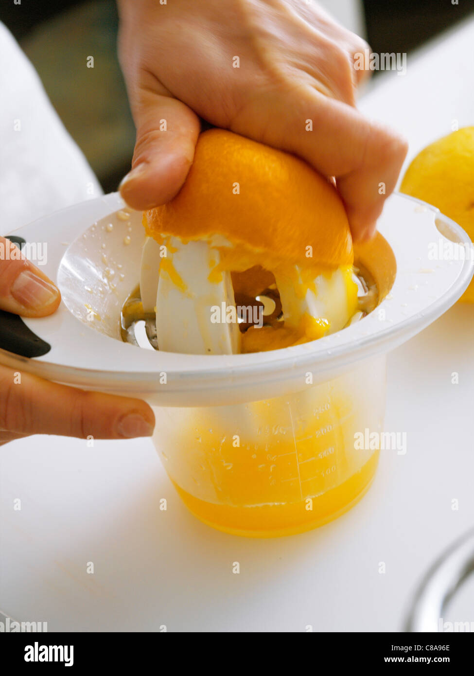 Squeezing an orange Stock Photo - Alamy