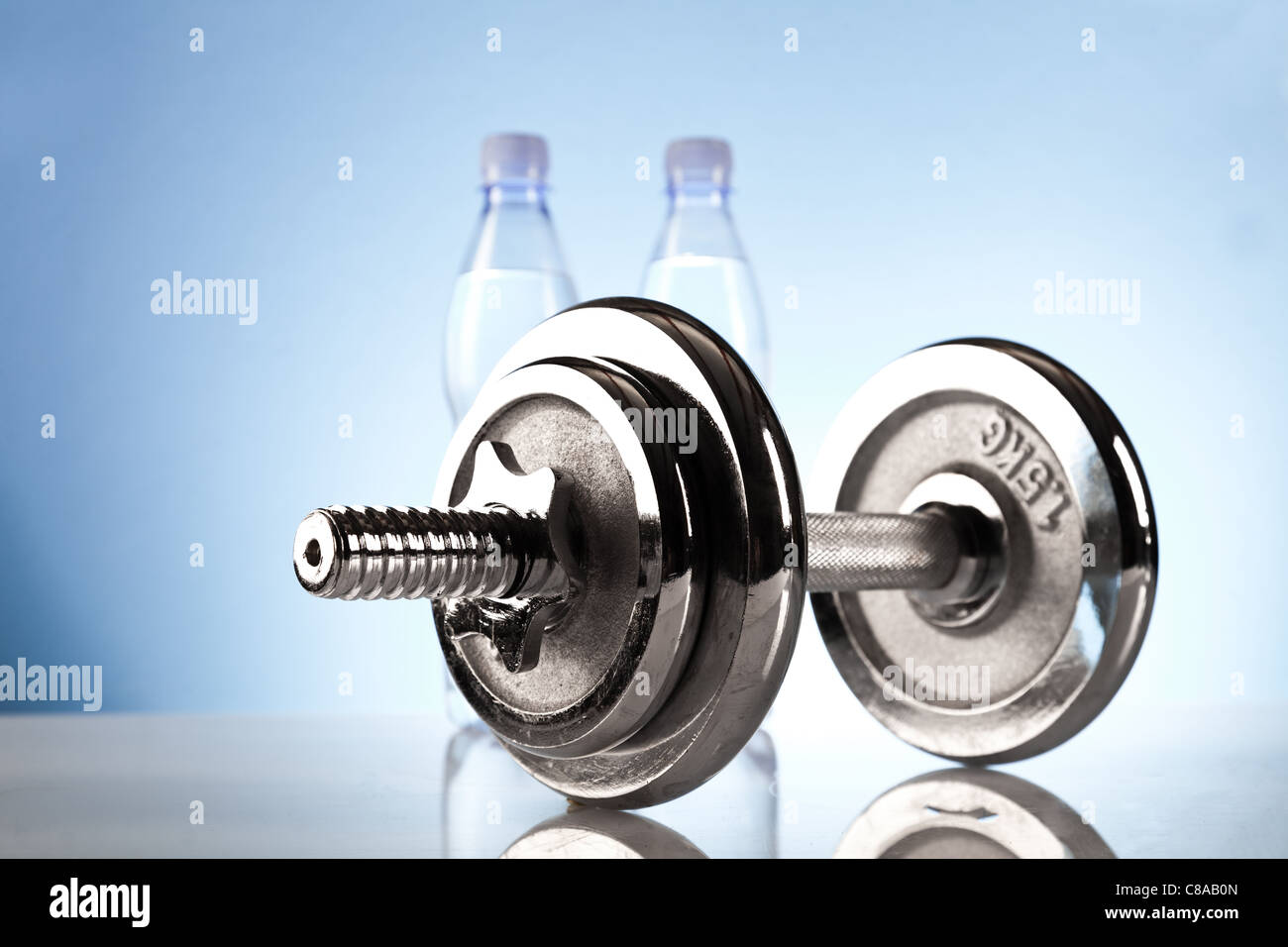fitness dumbbells on the blue background Stock Photo - Alamy