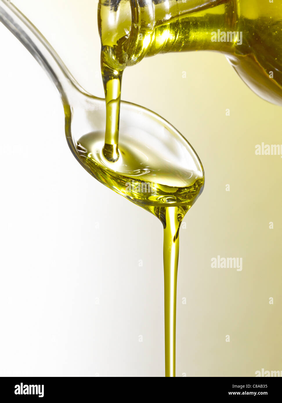 Pouring a spoonful of oil Stock Photo - Alamy
