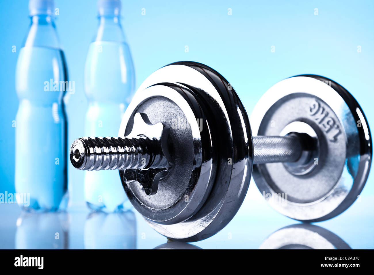 fitness dumbbells on the blue background Stock Photo - Alamy
