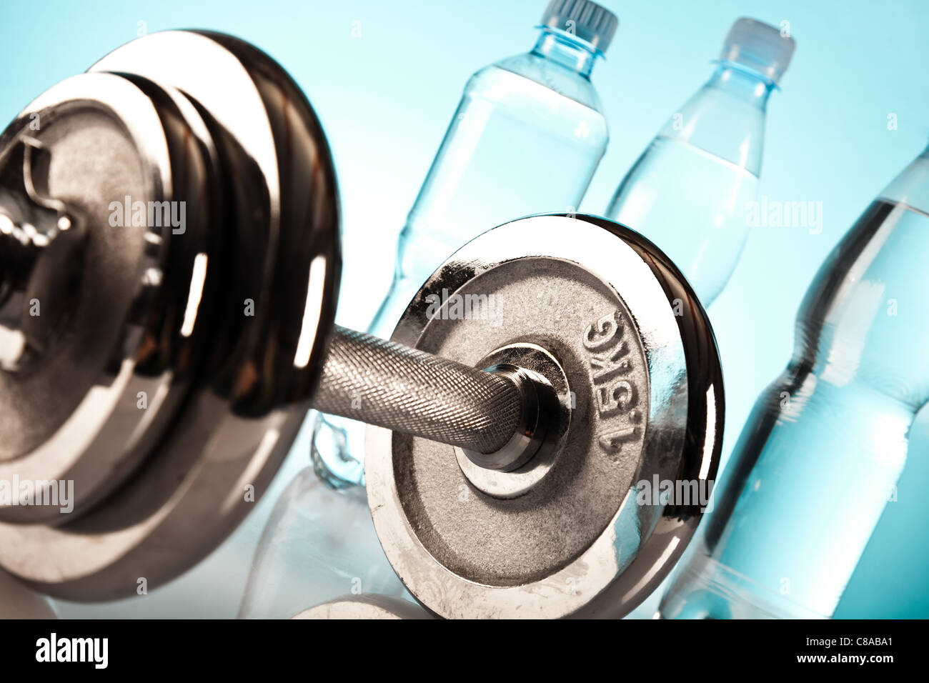 fitness dumbbells on the blue background Stock Photo - Alamy