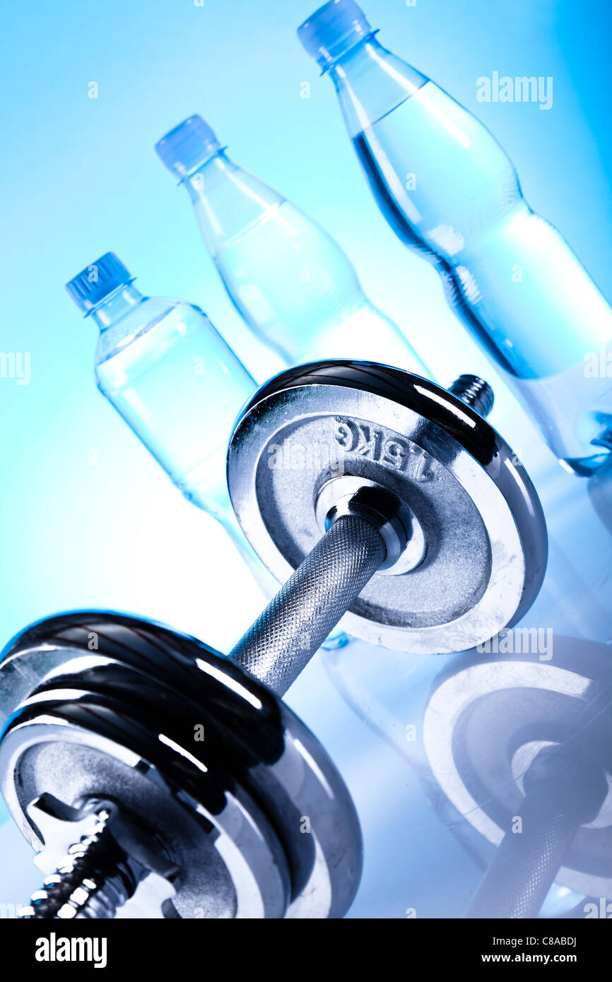 fitness dumbbells on the blue background Stock Photo - Alamy