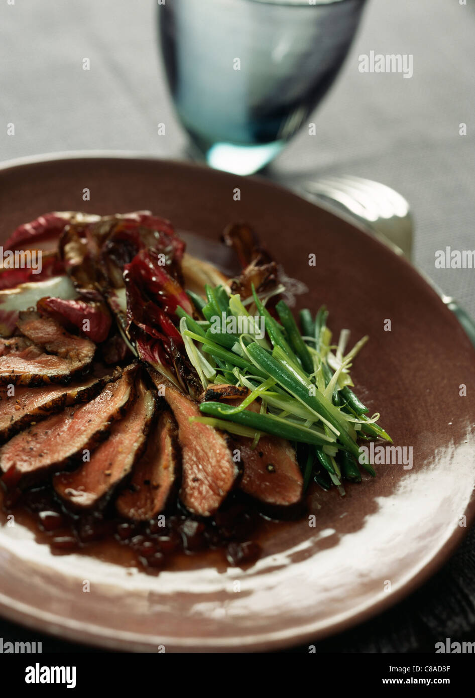 Grilled duck Magret with chicory of Trévise Stock Photo - Alamy