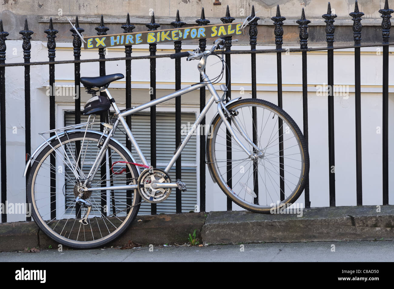 Bike for sale sign above bike padlocked to railing Stock Photo - Alamy