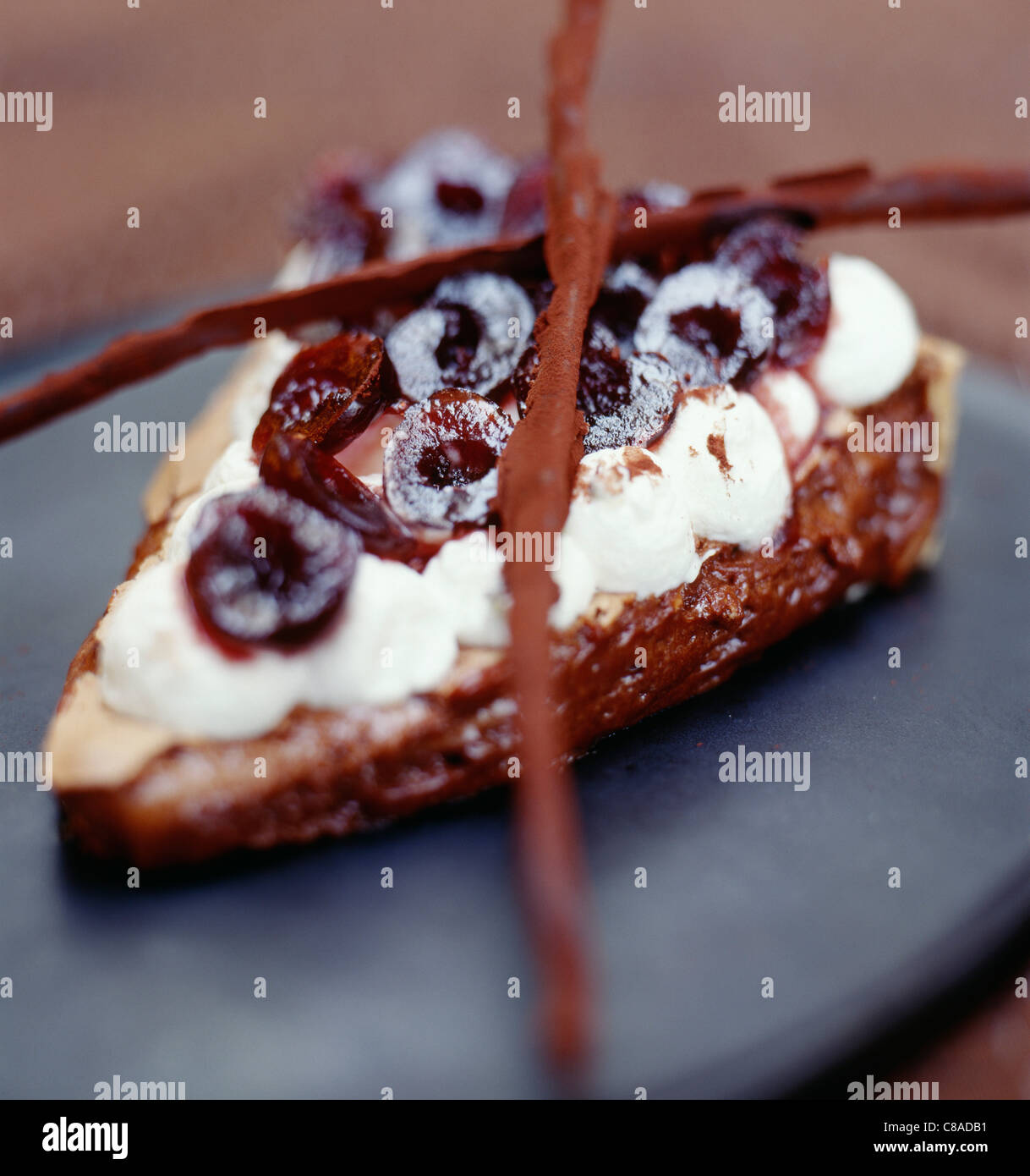 Cocoa and sour griotte cherry triangle dessert Stock Photo - Alamy