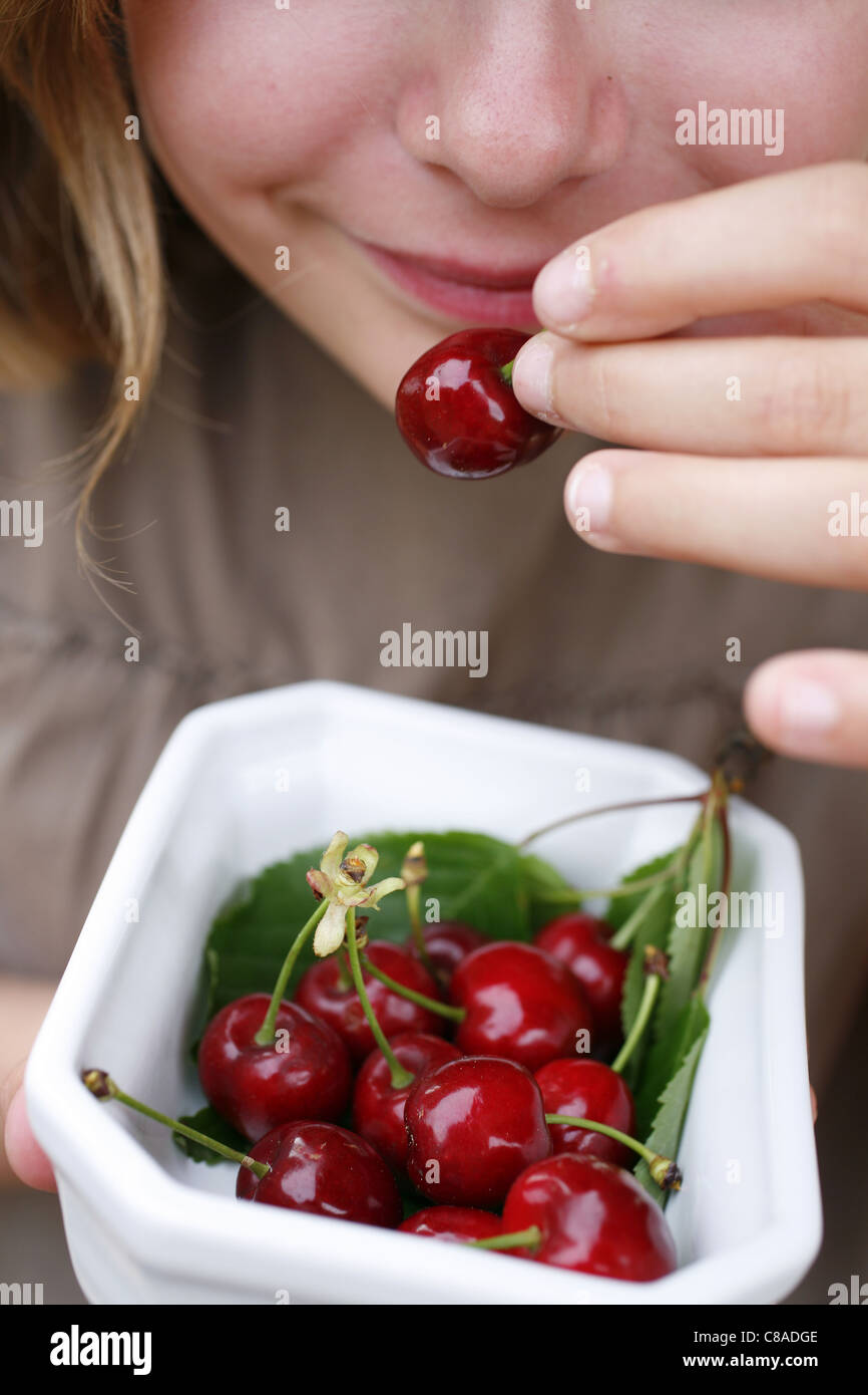 Child eating cherries Stock Photo - Alamy