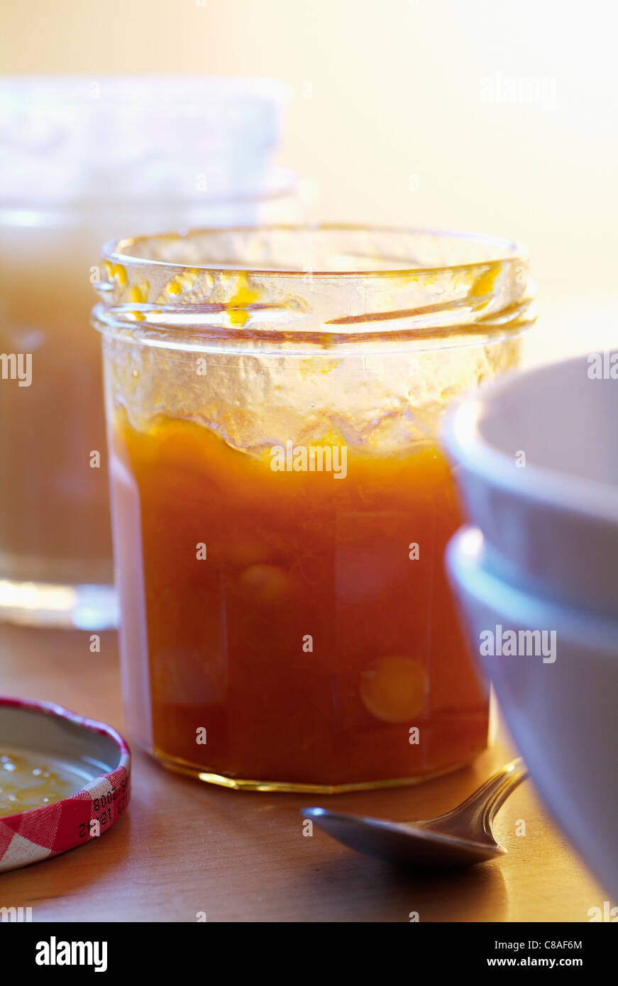 Pot of apricot jam on the breakfast table Stock Photo - Alamy