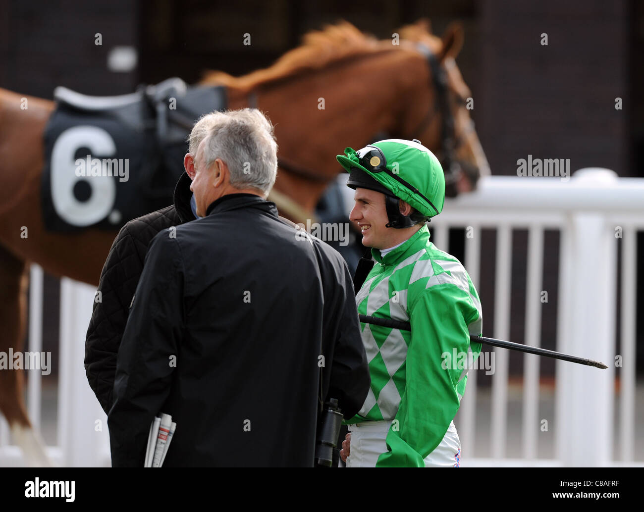 Jockey talking to Race Horse Owners Stock Photo - Alamy