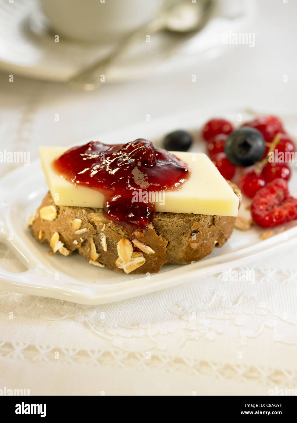Manchego cheese on a slice of bread with summer fruit jam Stock Photo ...