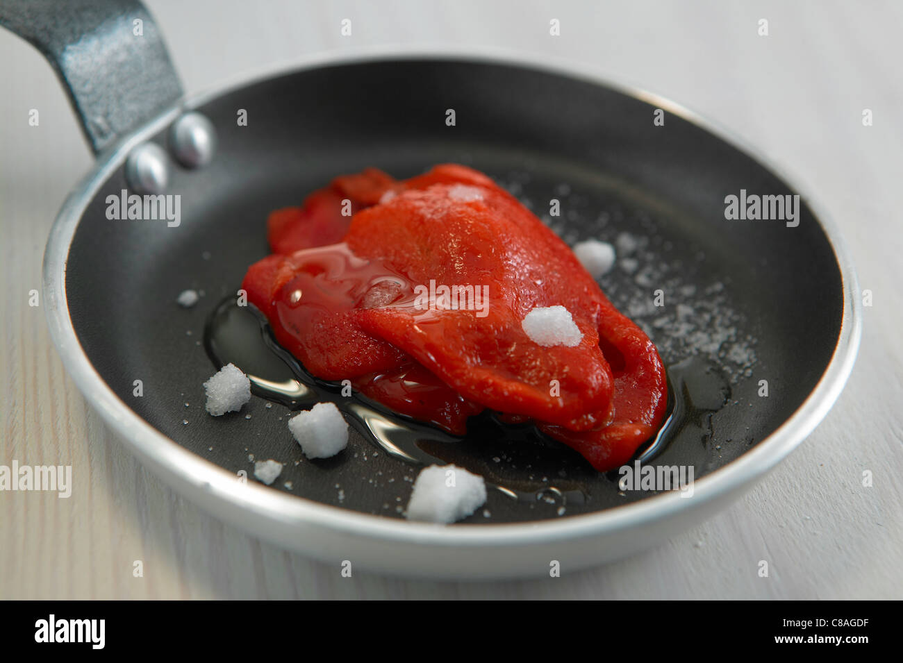 Frying skinned red peppers Stock Photo - Alamy