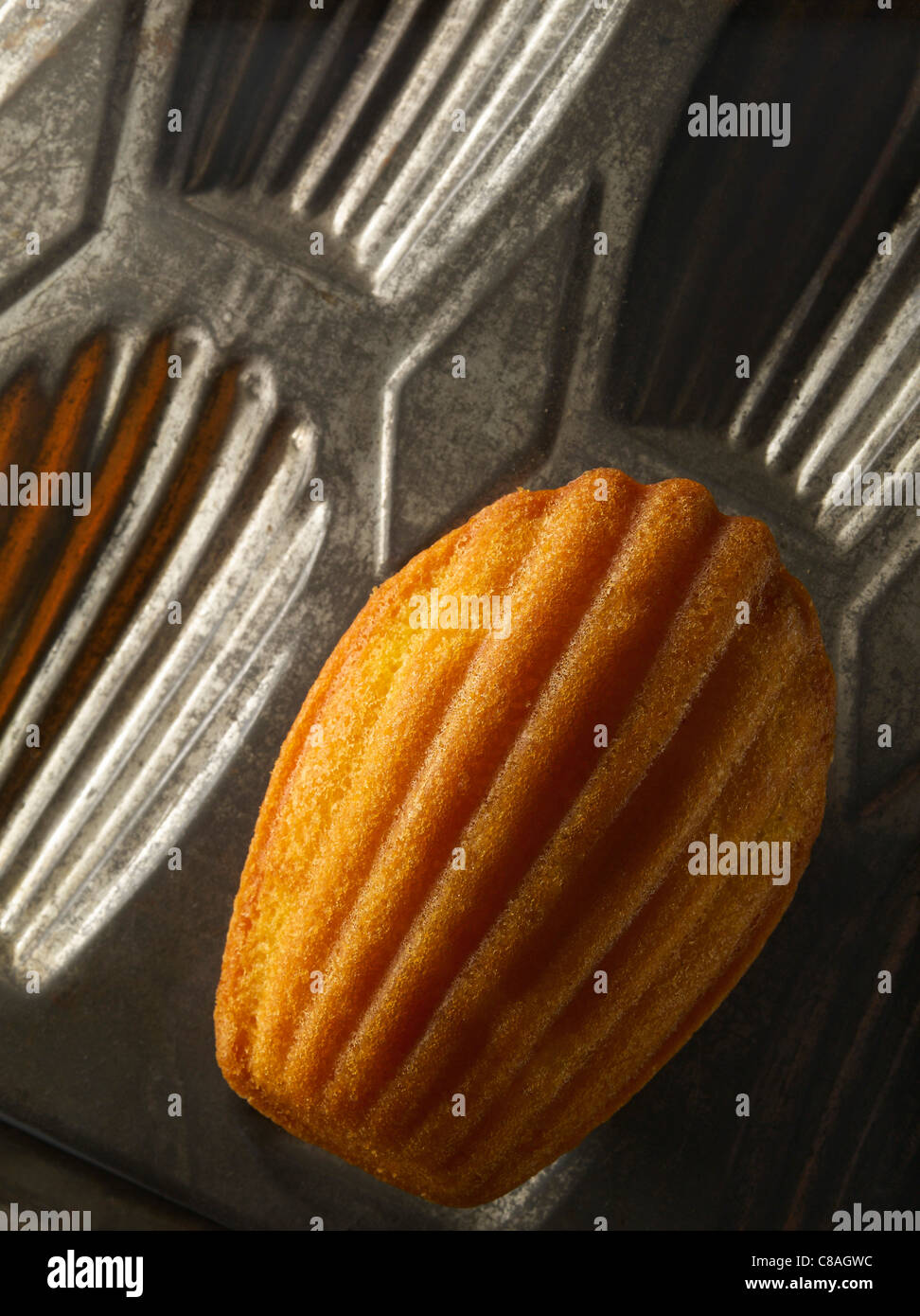 Madeleine in cooking mould Stock Photo - Alamy