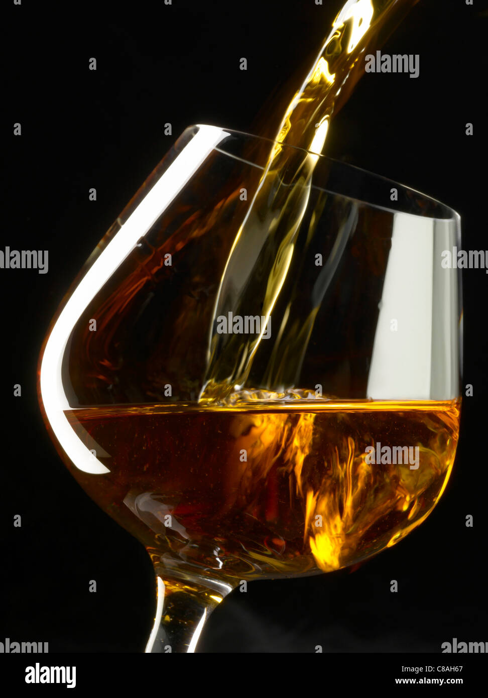 Pouring a glass of cognac Stock Photo - Alamy