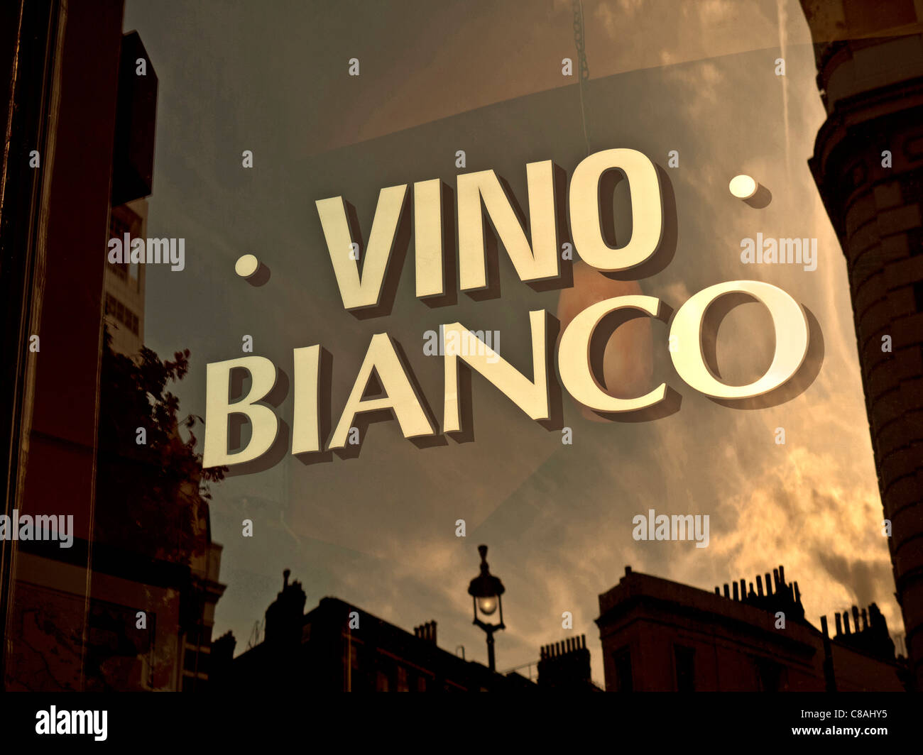 Sign on window of Italian wine bar reflecting sunset promoting Vino ...