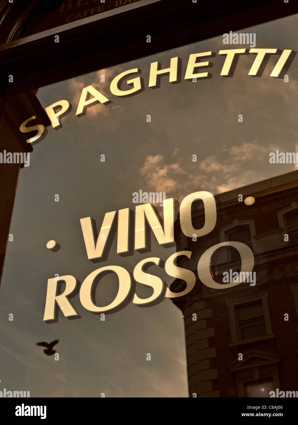 Sign on window of Italian wine bar at sunset promoting Spaghetti and ...