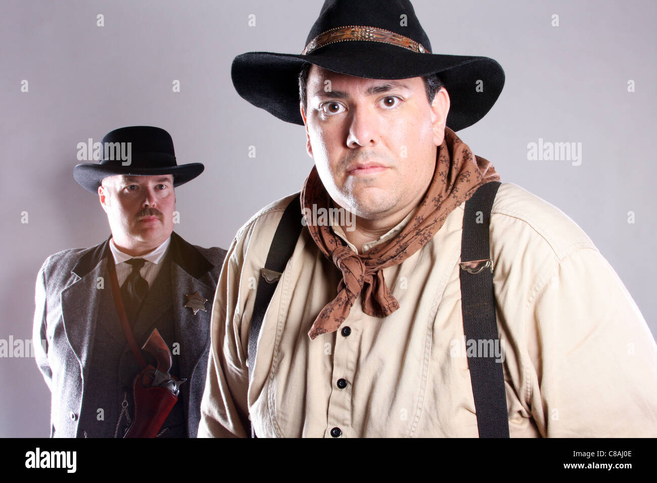 A cowboy under arrest with a sheriff Stock Photo - Alamy