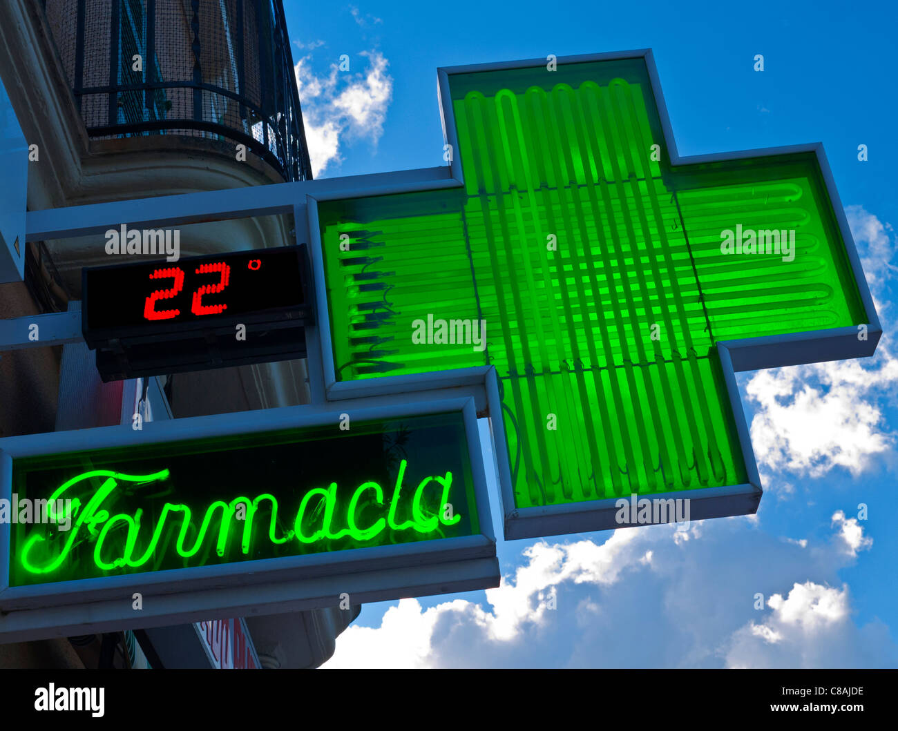 Spanish 'Farmacia' green cross sign showing 22C outside chemist ...