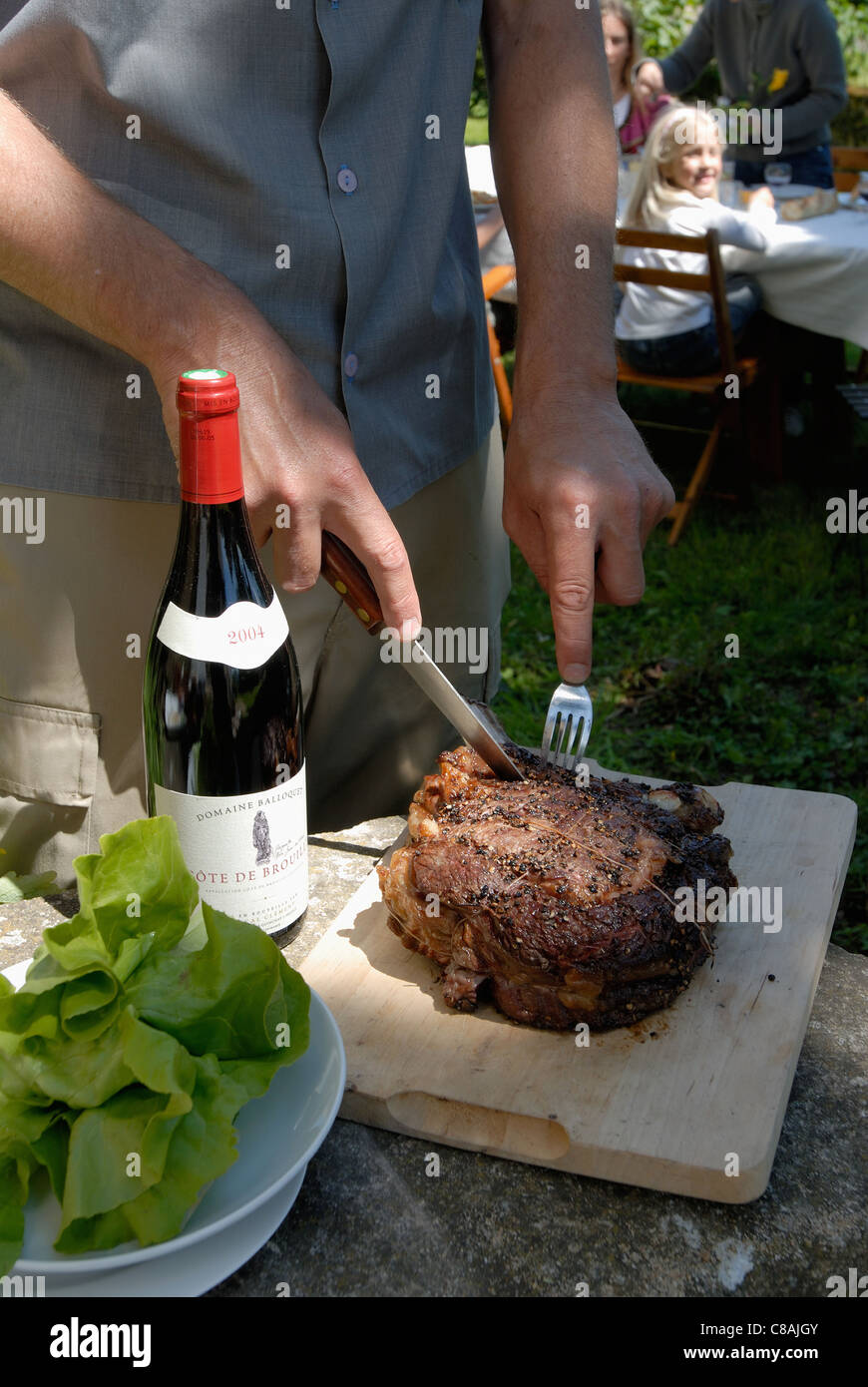 Cutting a large beef chop Stock Photo - Alamy