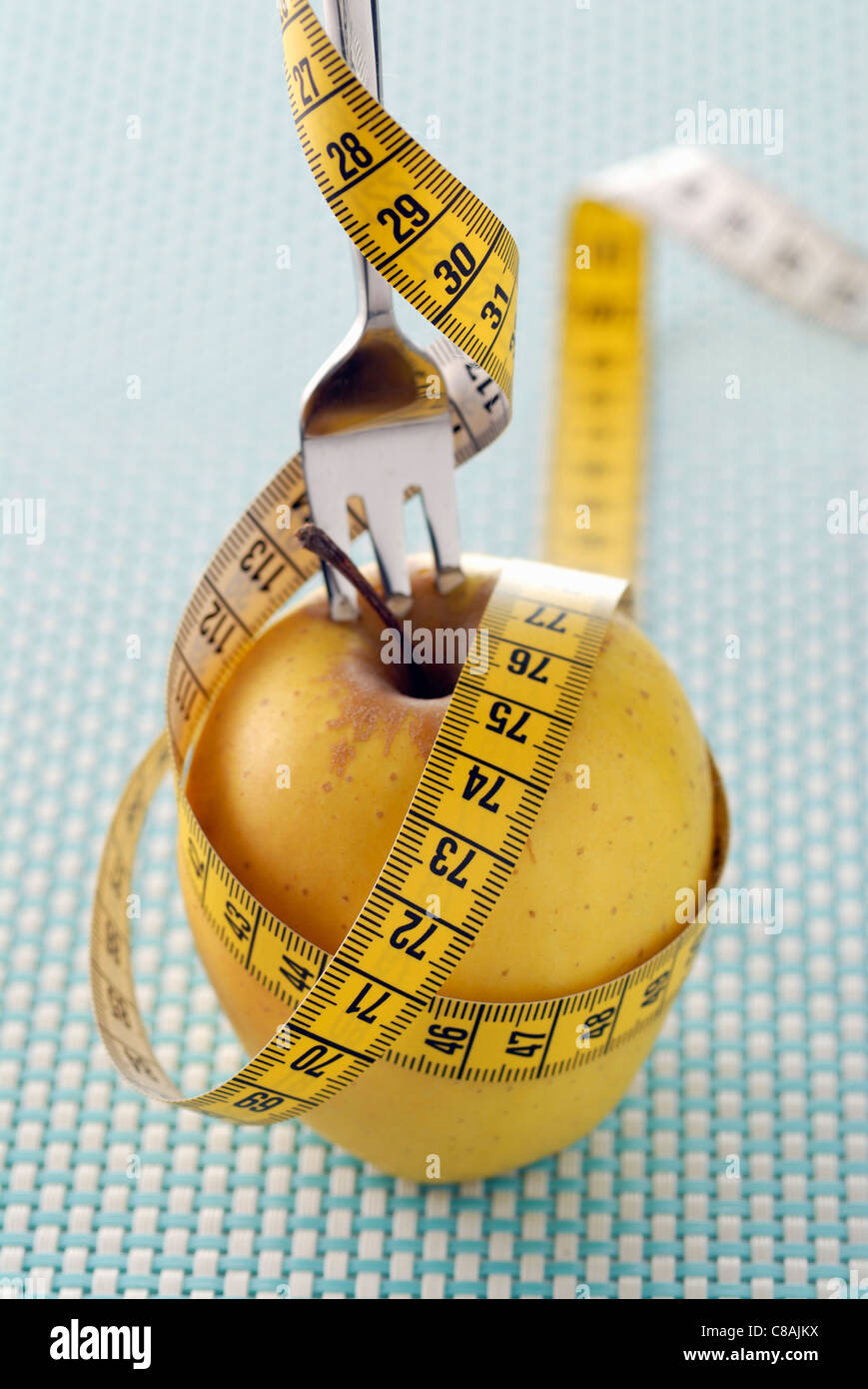 Apple and measuring tape Stock Photo - Alamy