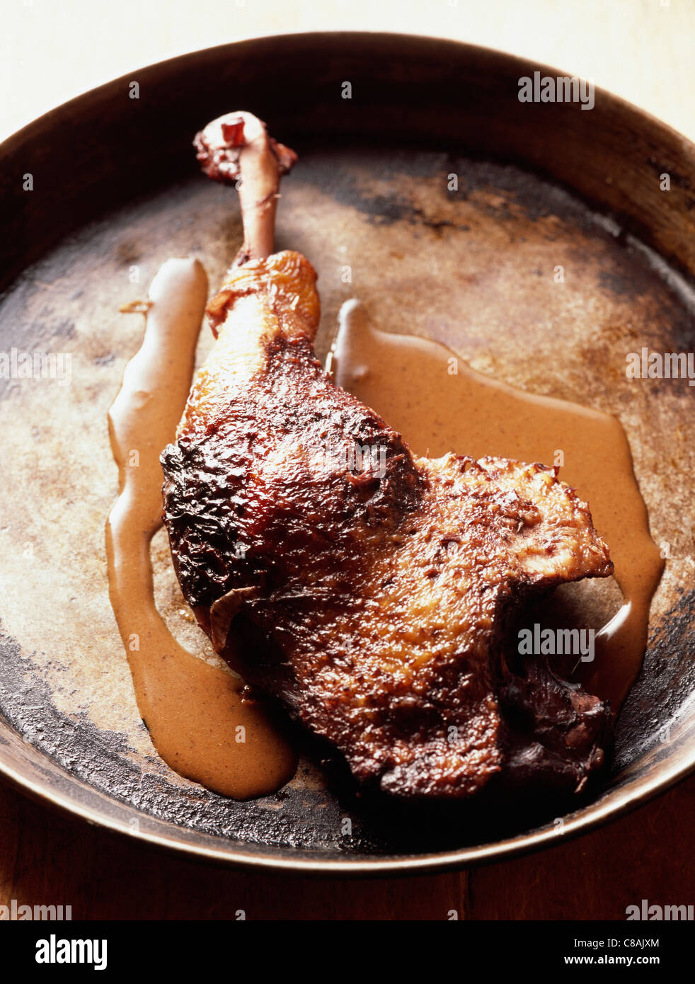 Leg of duck conserve with red wine sauce Stock Photo - Alamy