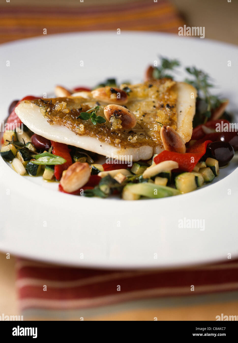 Pan-fried Saint-Pierre fillet and vegetables with almonds and olives ...
