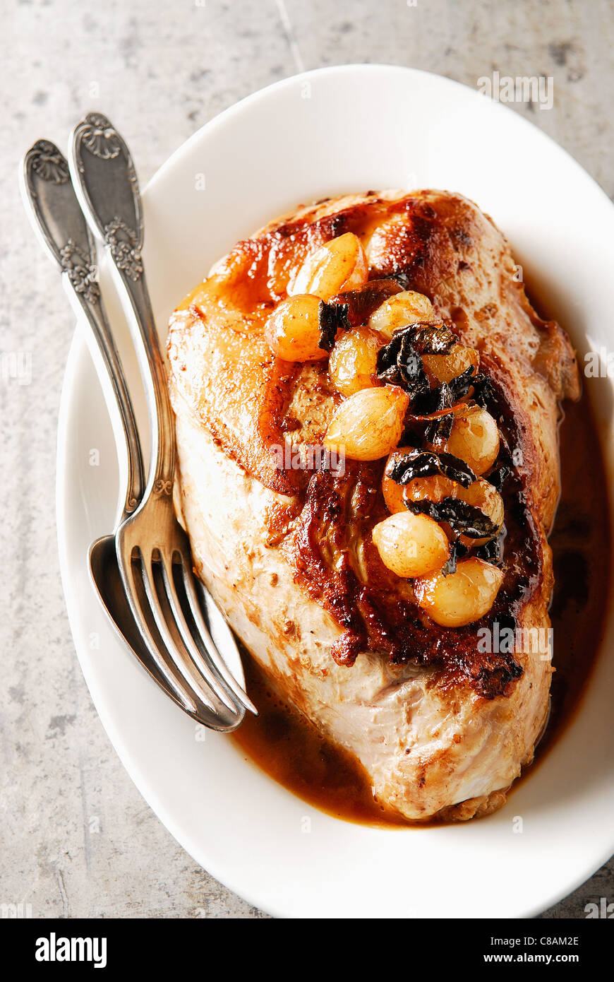 Roast veal rump with small onions and sage Stock Photo - Alamy