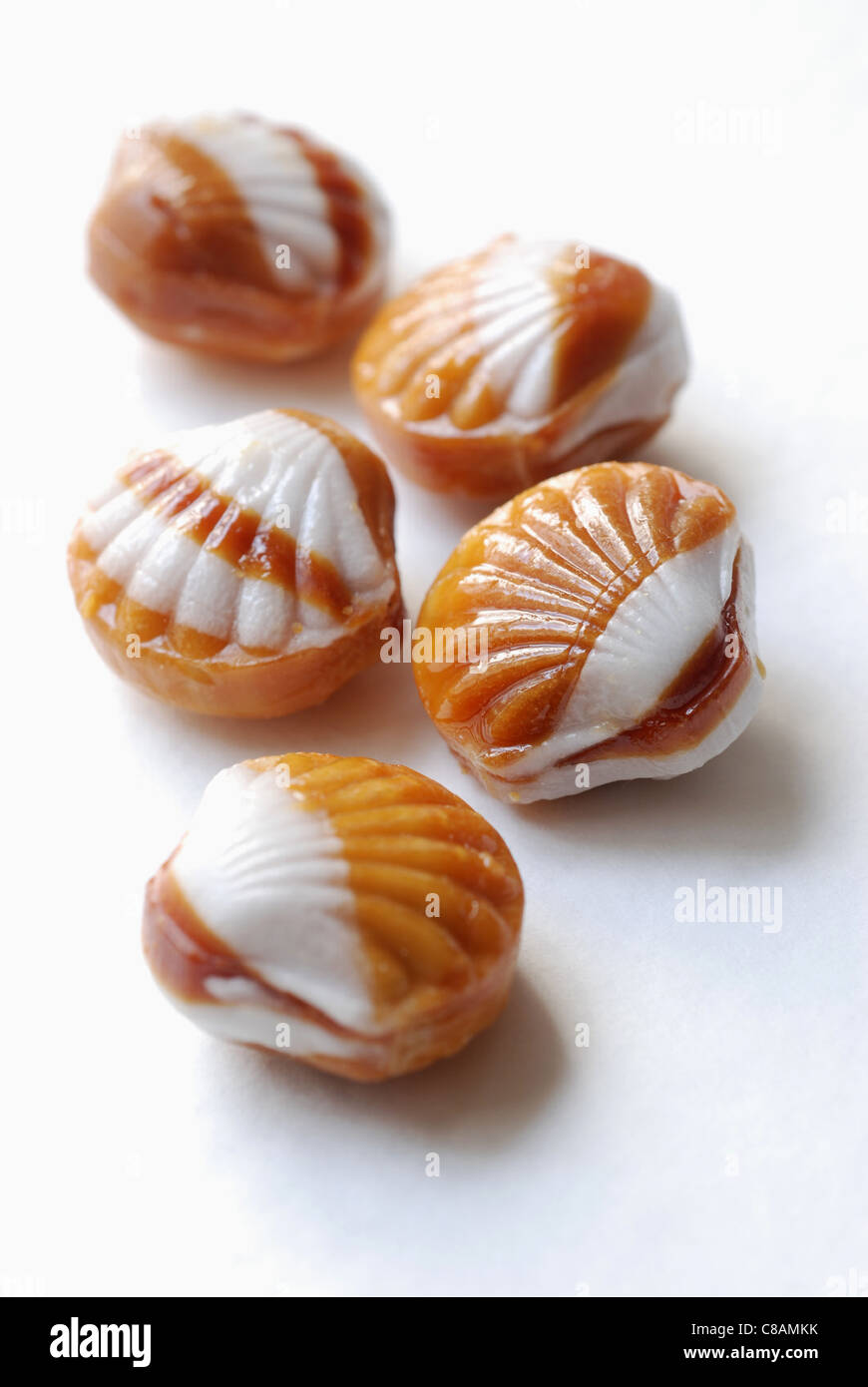 Shell-shaped caramel sweets Stock Photo - Alamy