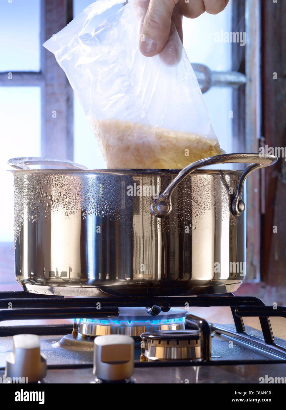 Rice boiling in saucepan hi-res stock photography and images - Alamy