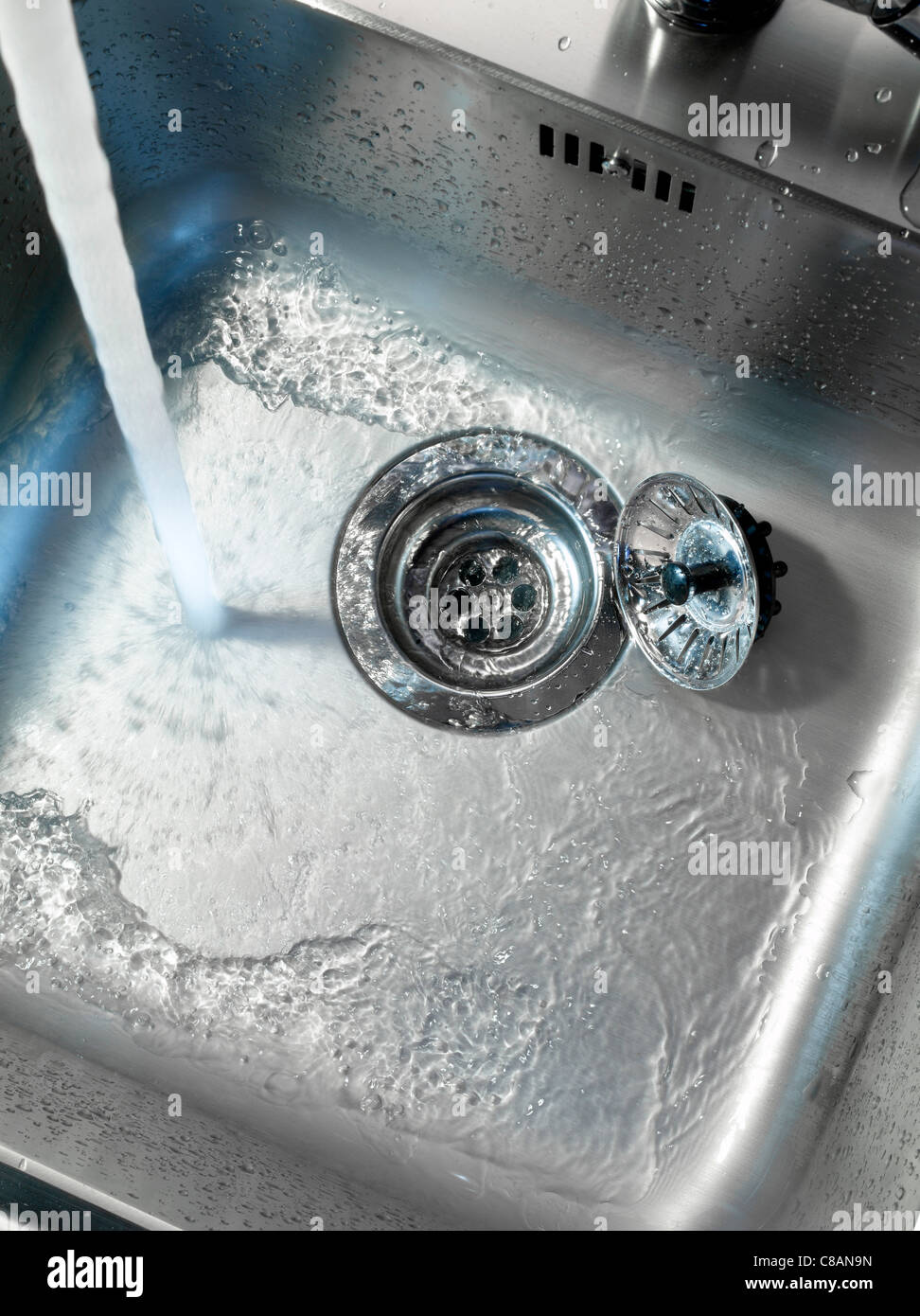 Water runnig from the tap in the sink Stock Photo - Alamy