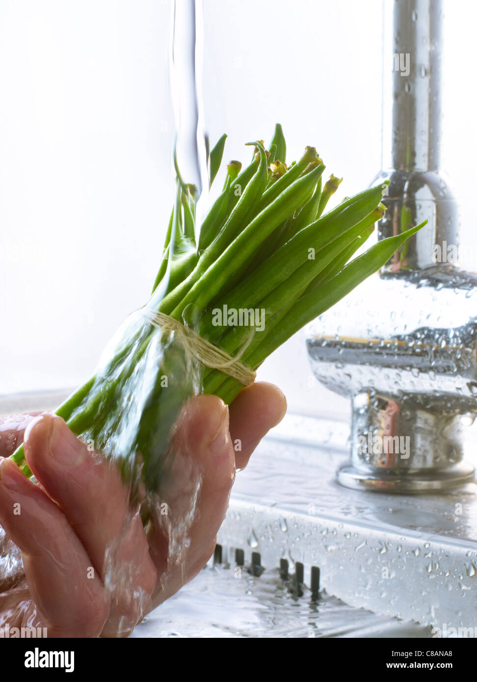 Rinsing a bundle of green beans under the tap water Stock Photo - Alamy