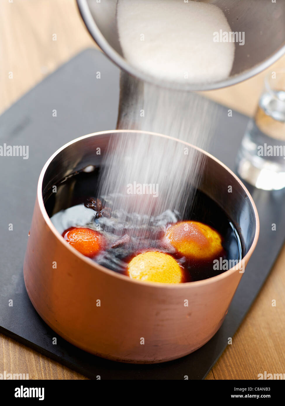 Adding the sugar to the wine and citrus fruit Stock Photo - Alamy