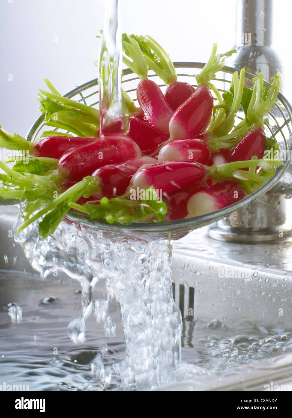 Washing radishes in sink hi-res stock photography and images - Alamy
