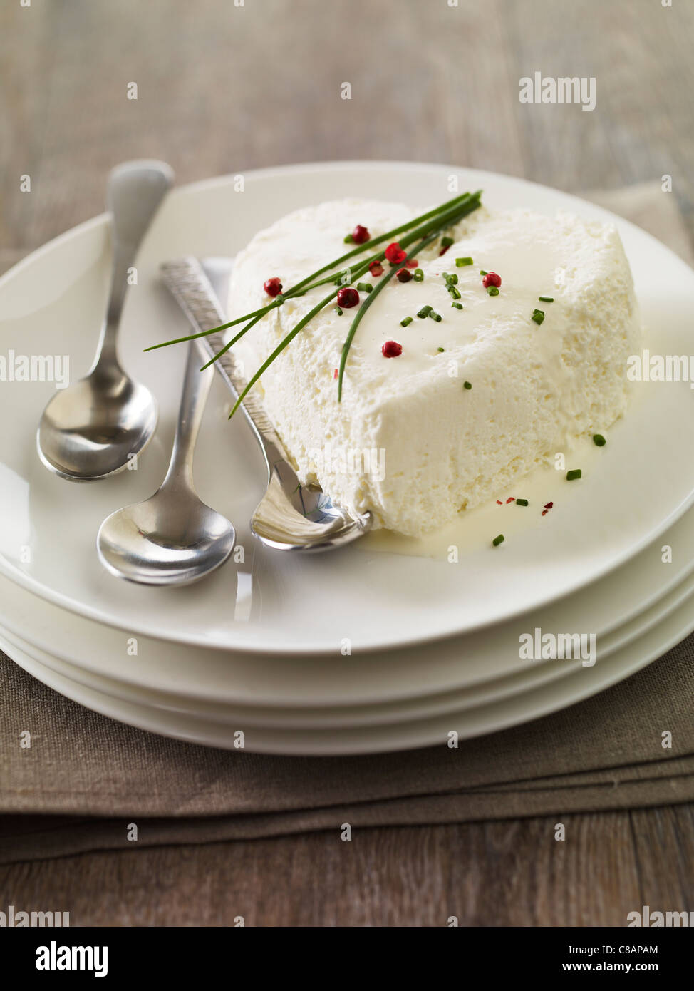 Faisselle with chives and pink peppercorns Stock Photo - Alamy
