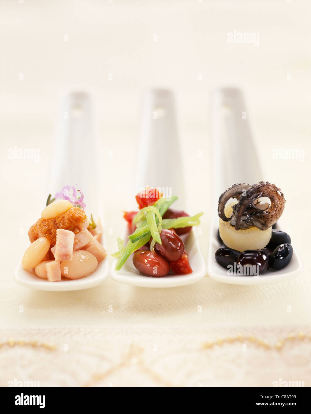 Three spoons of different bean tapas Stock Photo - Alamy