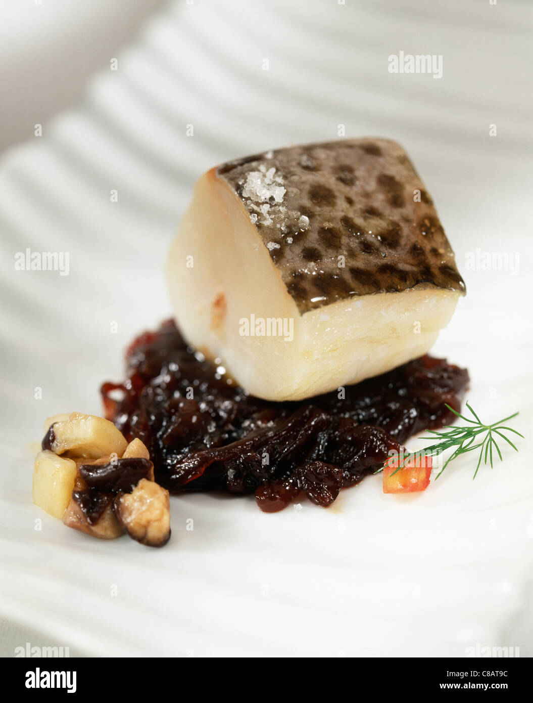 Cube of grouper marinated with brown seaweed Stock Photo - Alamy