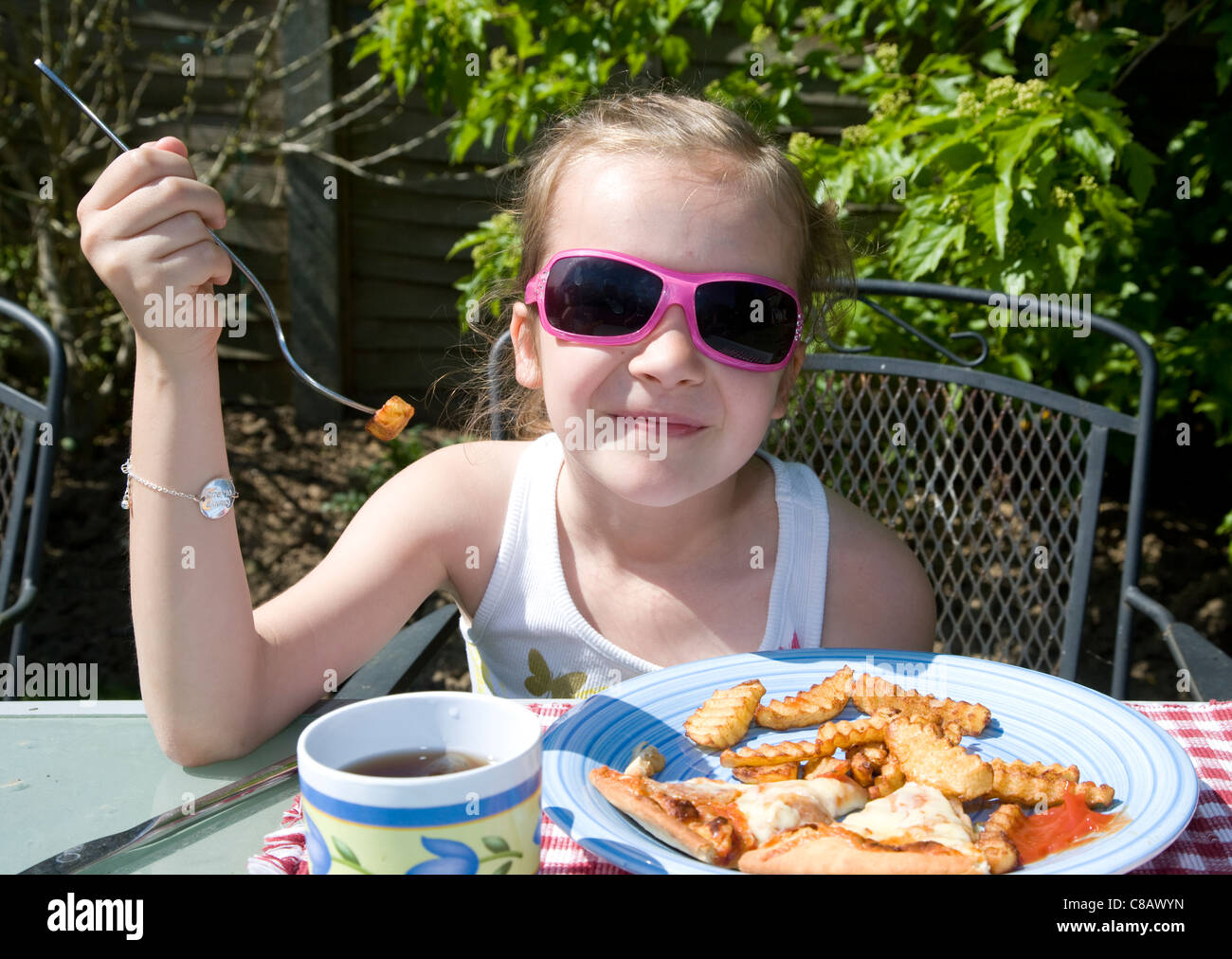 Girl eating lunch in garden Stock Photo - Alamy