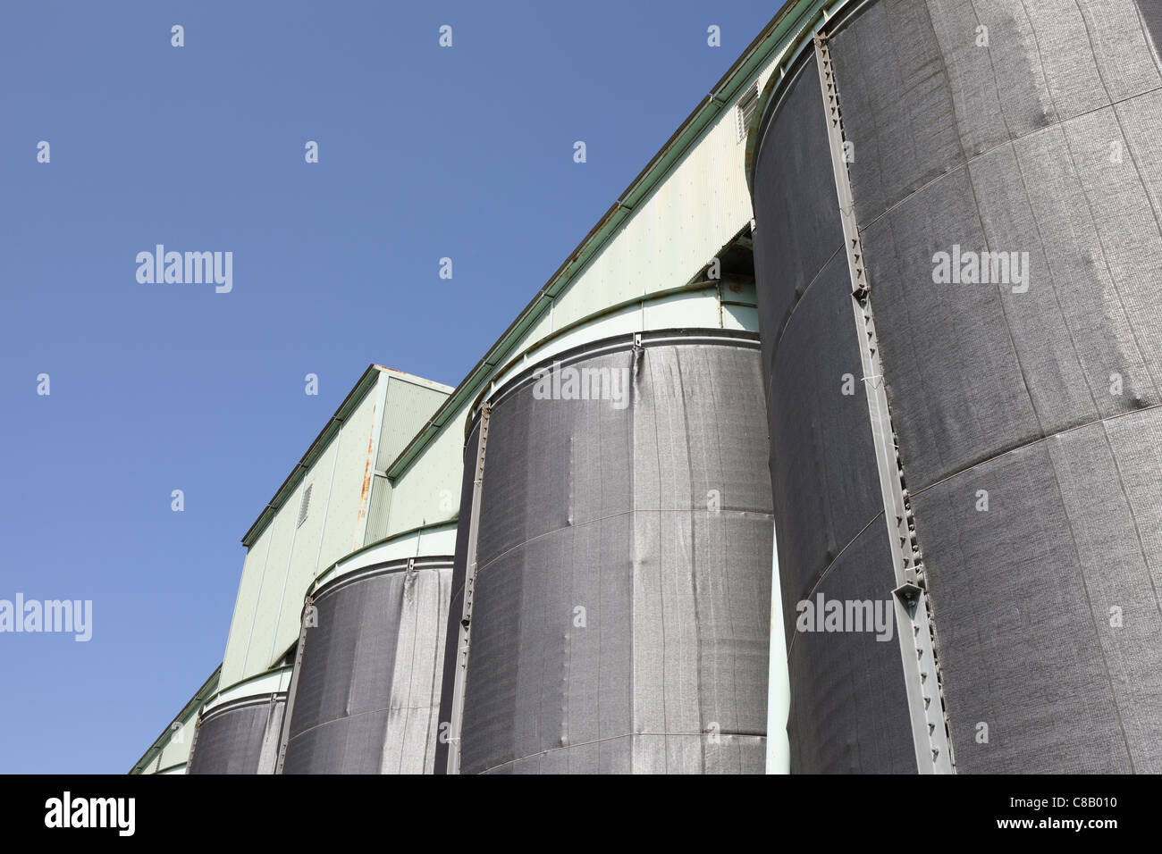 Photograph of industrial storage silo and blue sky Stock Photo - Alamy