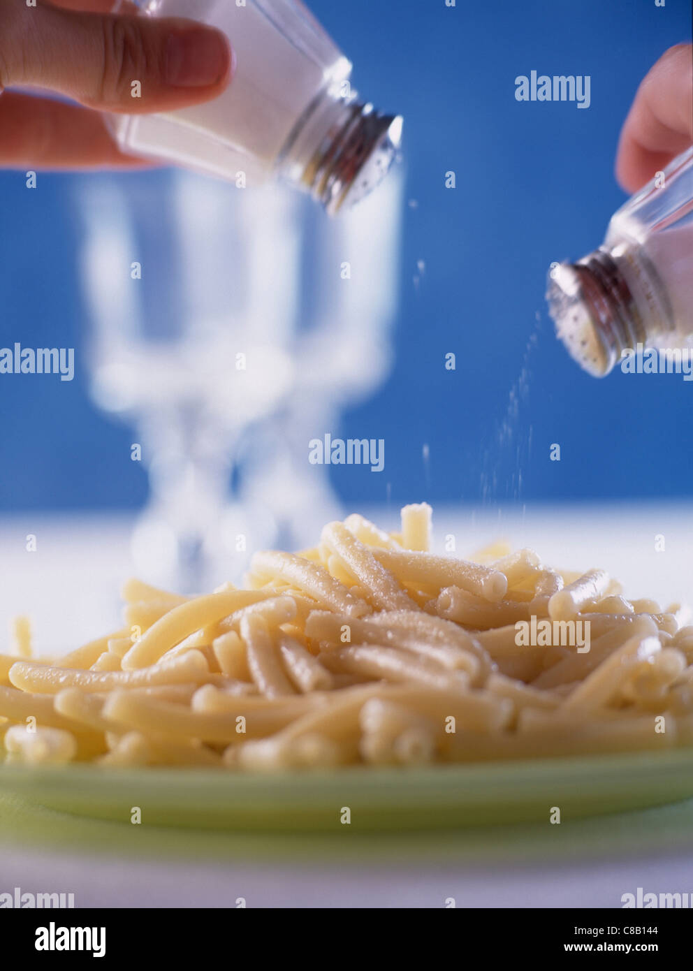 Pouring salt on pasta Stock Photo - Alamy