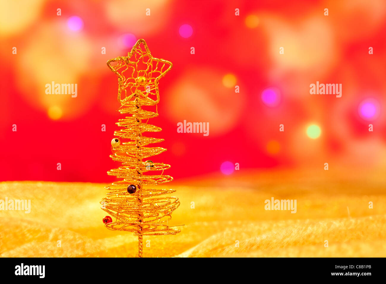 Christmas golden wire tree in blurred lights background Stock Photo - Alamy