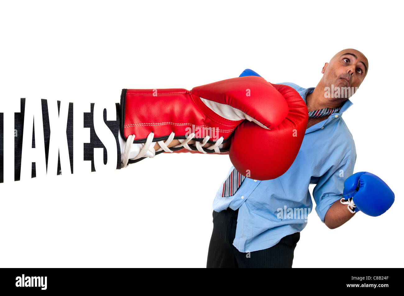 Businessman taking a hit by the taxes hand Stock Photo - Alamy