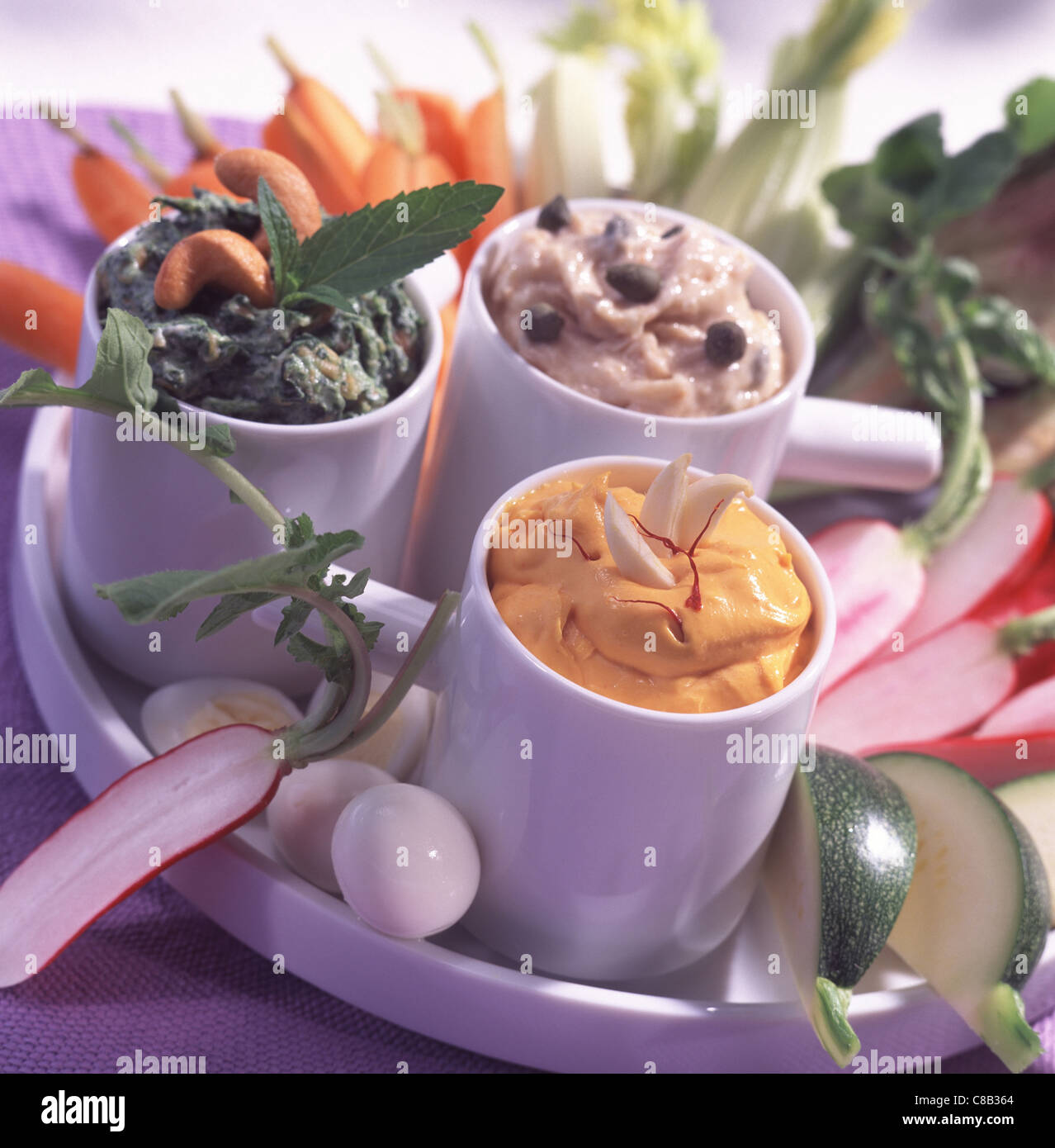 Raw vegetables and three dips Stock Photo - Alamy